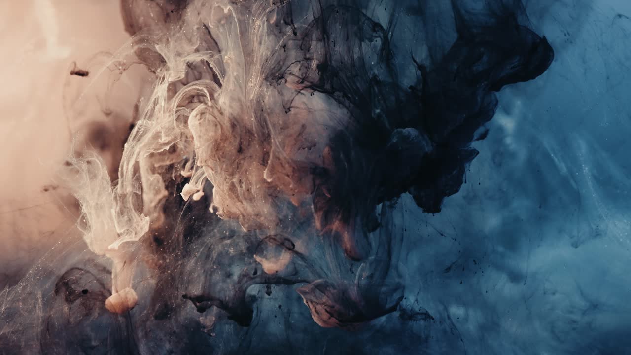 Slowmotion Shot Of Color Ink In Water Lighting In Yellow And Blue ...