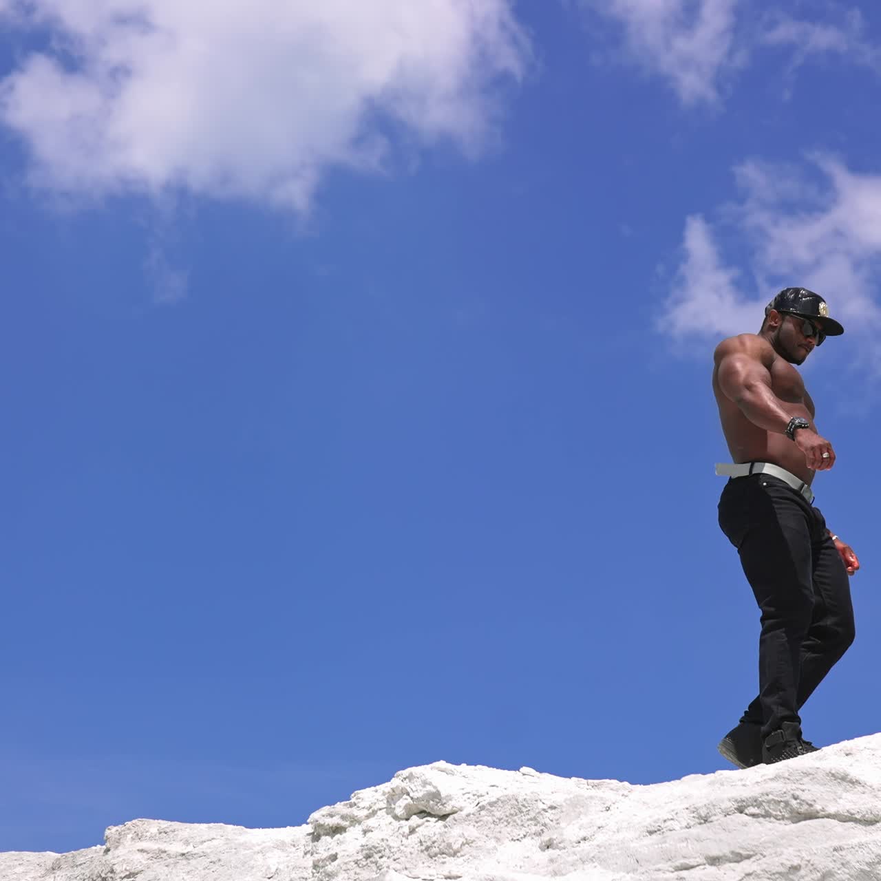 Afro american athlete on blue sky background. Dark skinned bodybuilder ...