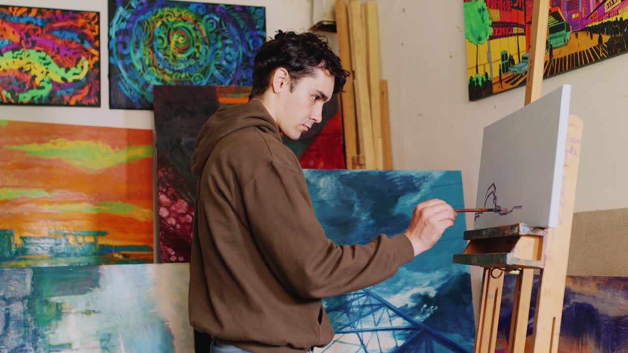 Premium stock video - Cute artist draws a picture in the studio the ...