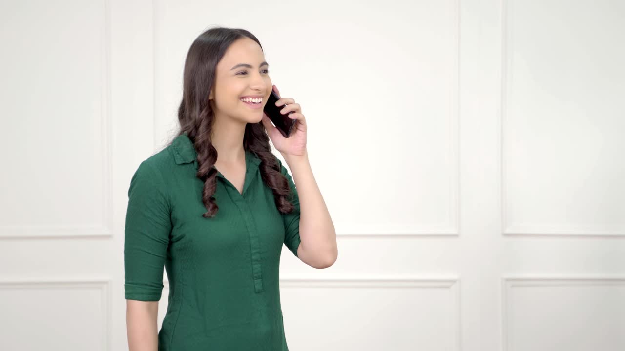 Premium stock video - Happy indian girl talking on a call