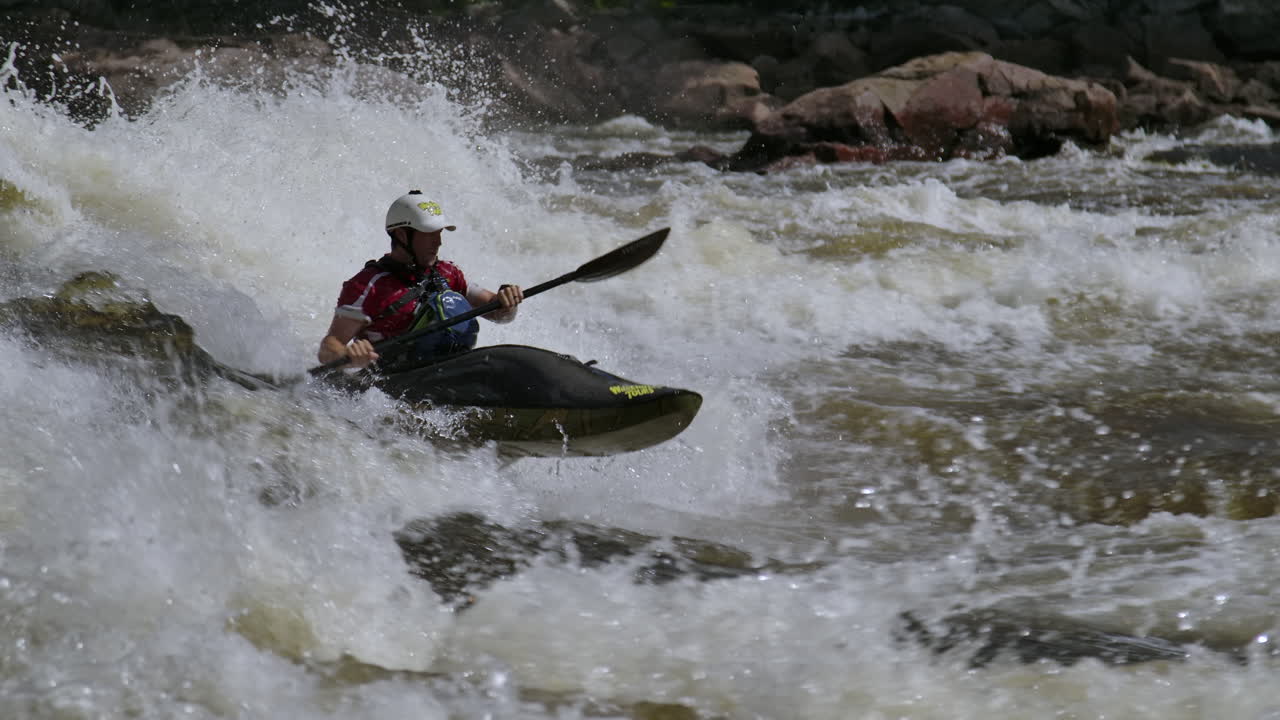 Premium stock video - Extreme white water kayak athlete slow motion