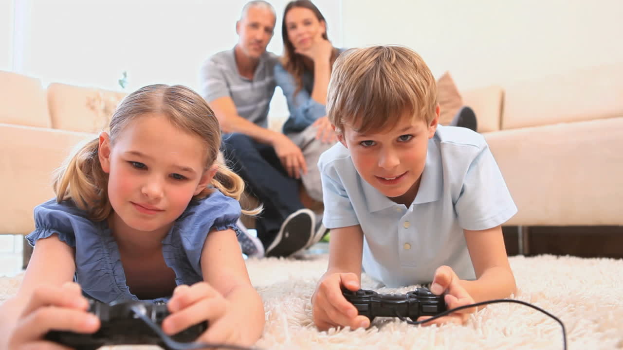Premium stock video - Cute children playing video games