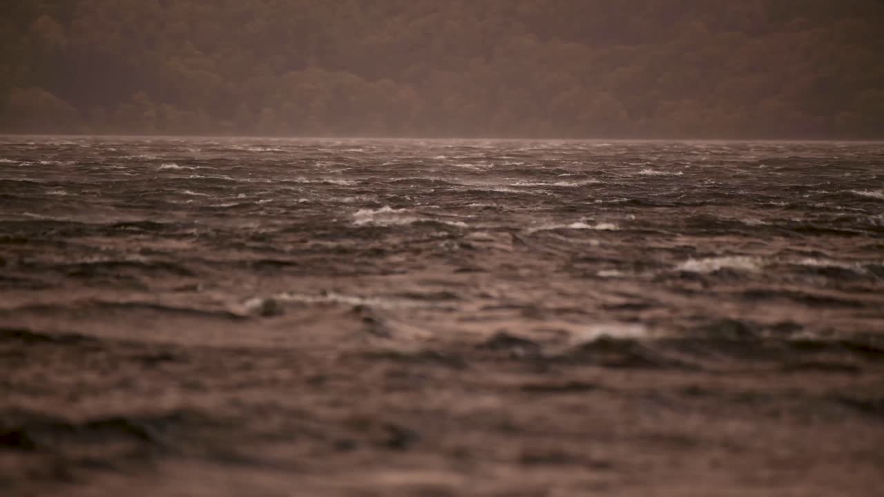 Premium stock video - Extreme gale force winds blowing across a loch in ...