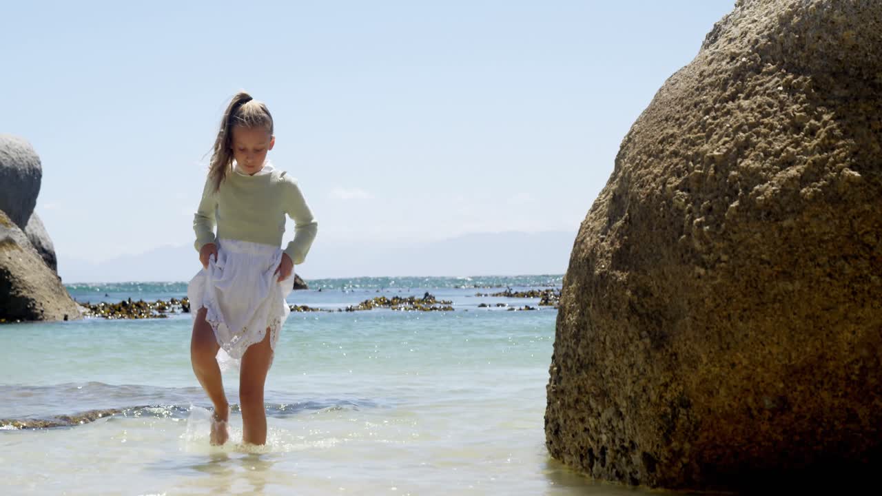 Premium stock video - Girl walking on water in the beach 4k