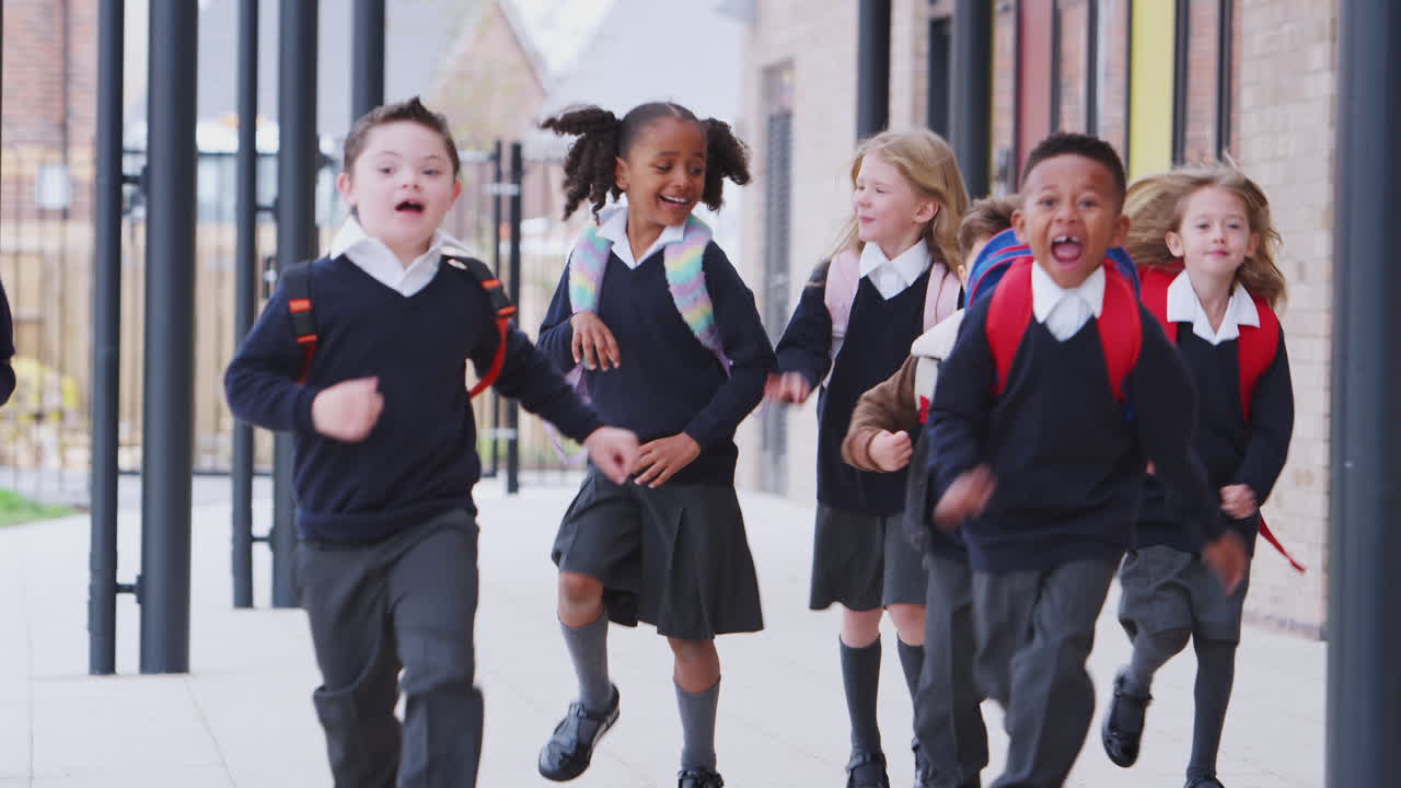 Premium stock video - Happy primary school kids in uniforms running on ...