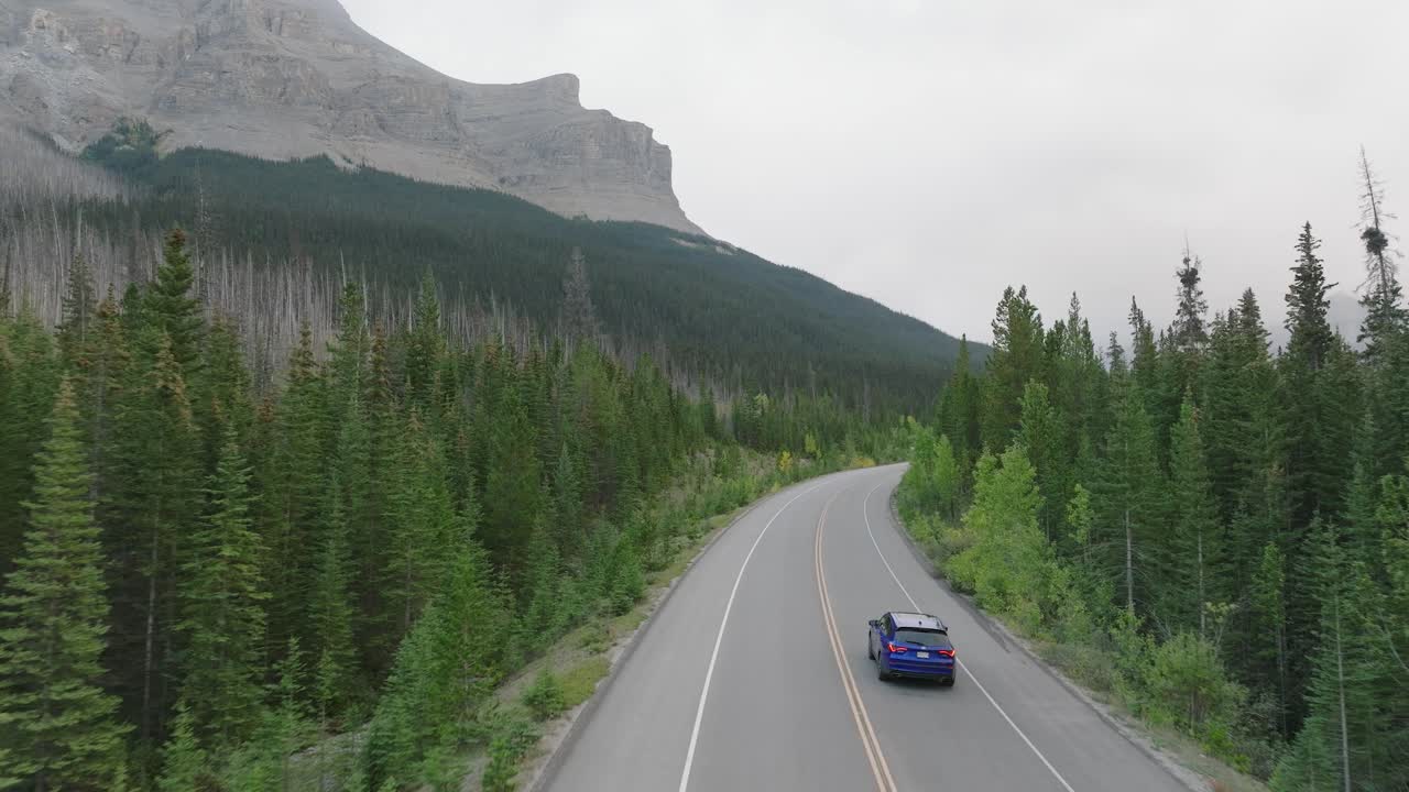 Premium stock video - Aerial dolly in of car driving on road between ...