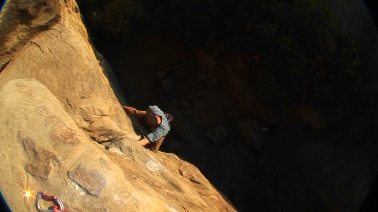 Aerialshot Of A Rock Climber Climbing Up A Cliff Face | Premium Stock ...