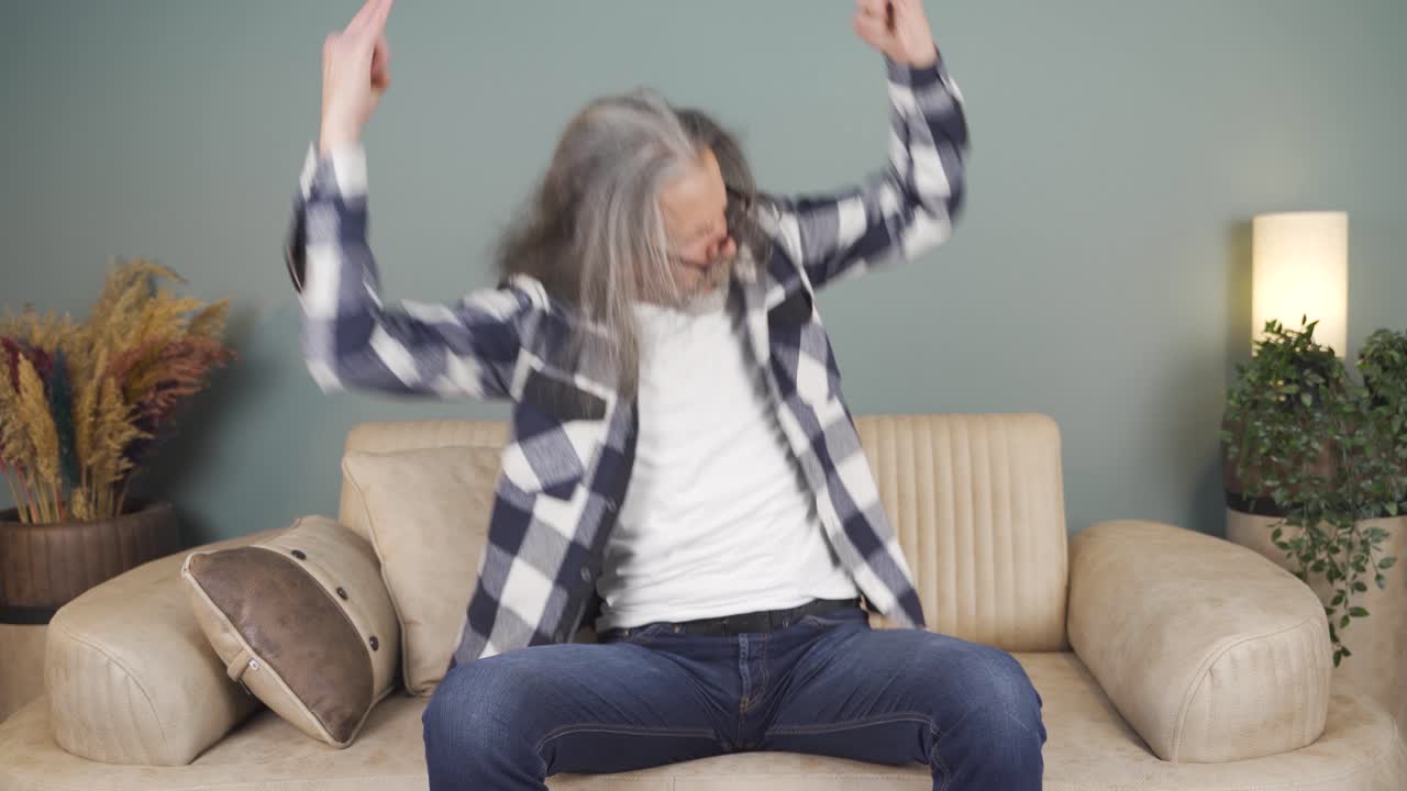 Premium stock video - Man doing rocker sign and dancing.