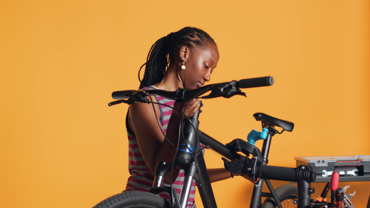 Mechanic setting up bike repair stand, studio background Premium Stock ...