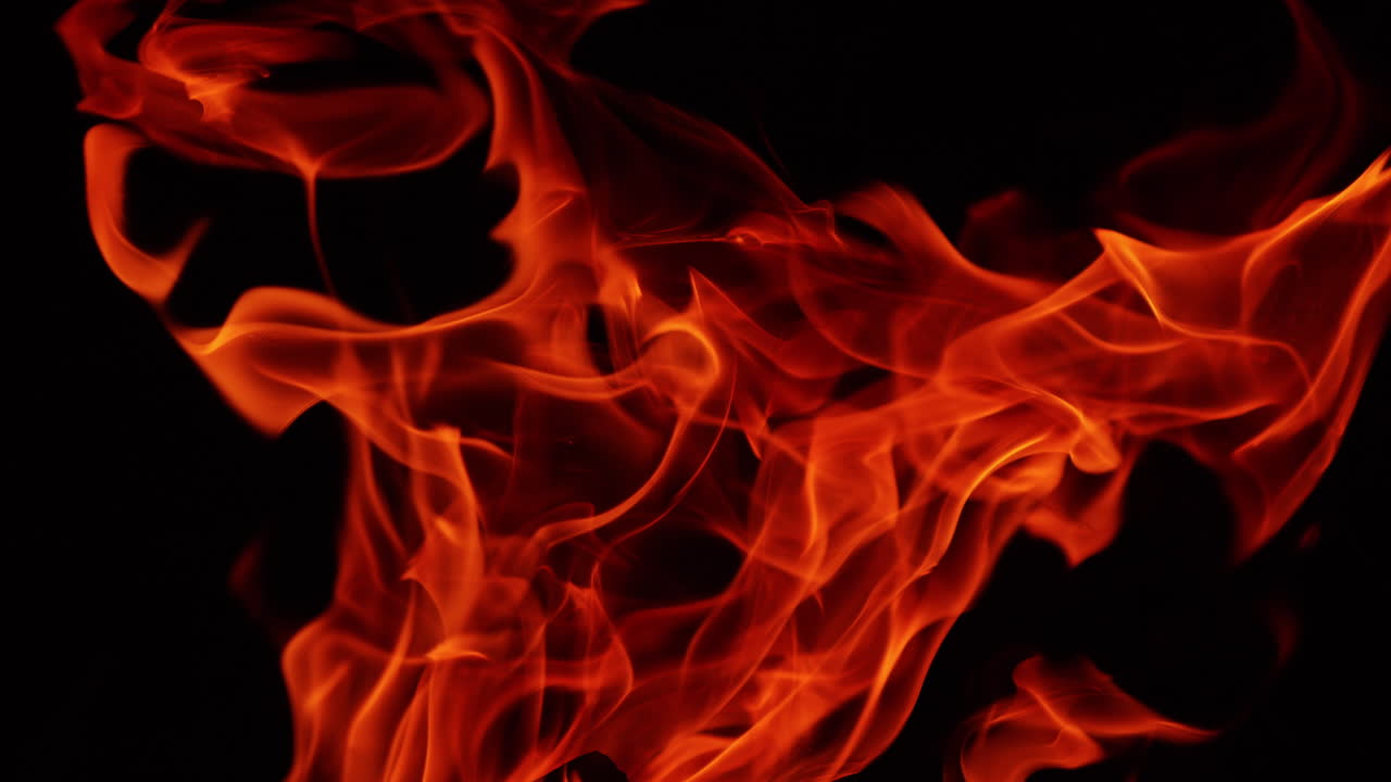 Quickly moving flames of bonfire in the wind outdoors. Fire burning at ...