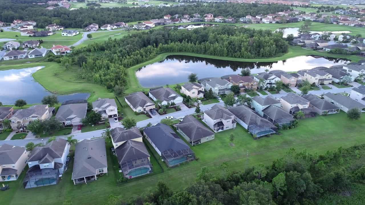 An aerial flyover of a residential subdivision HOA single family homes ...