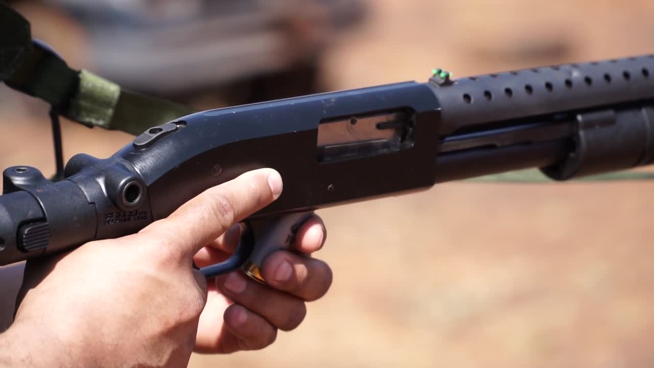 Premium stock video - Person is reloading a shotgun with bullet shells ...