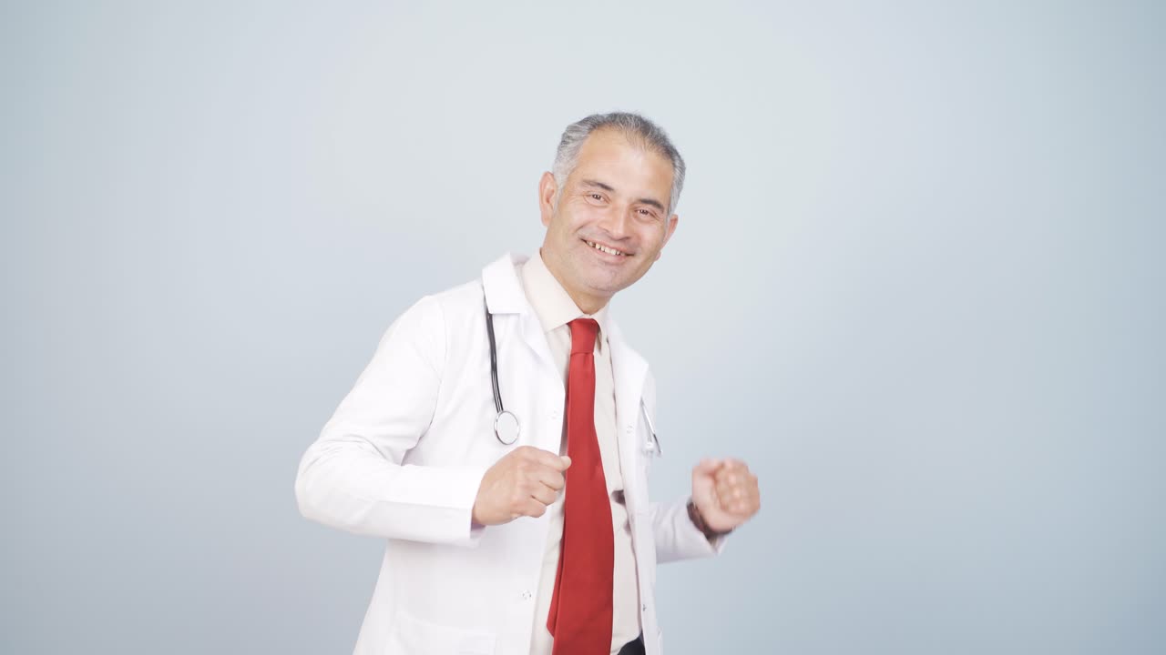 Premium stock video - Dancing doctor. happy and cute.