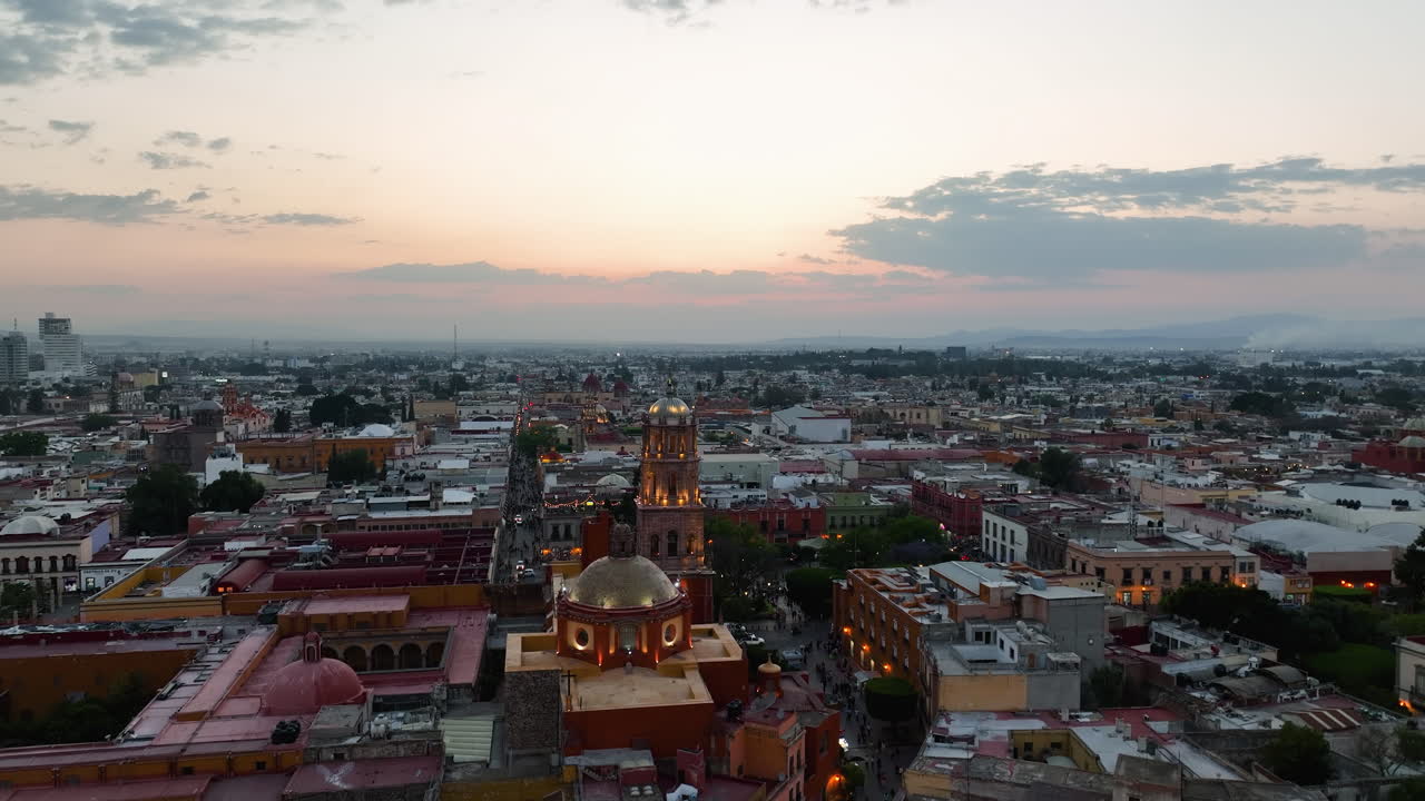 Aerial view rising over the Templo de San Francisco church, dusk in ...