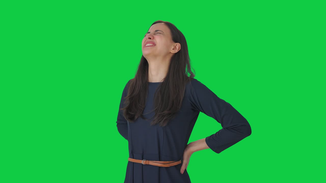 Premium stock video - Indian girl suffering from back pain green screen