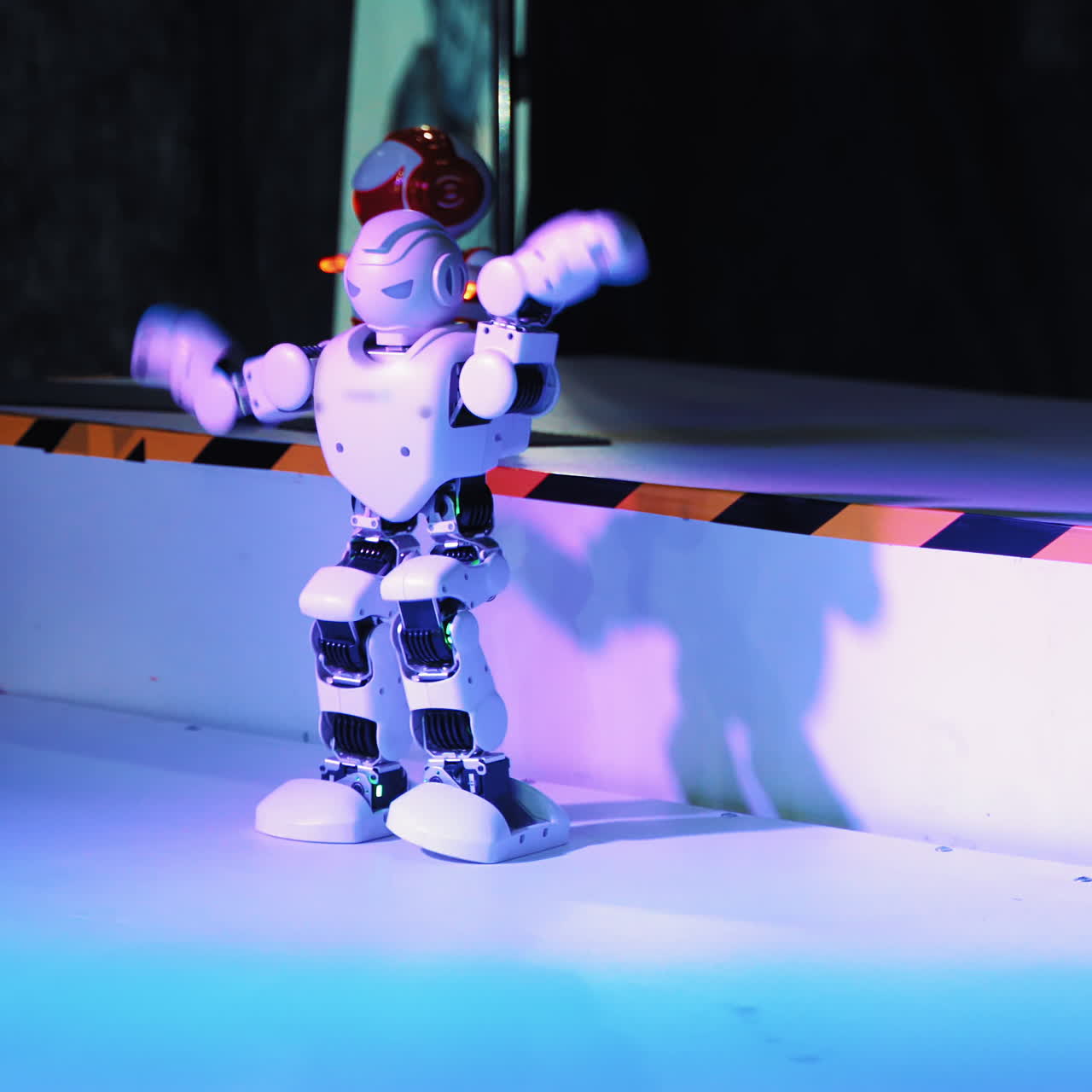 Humanoid robot dance. Group of cute robots dancing. Close up of smart ...