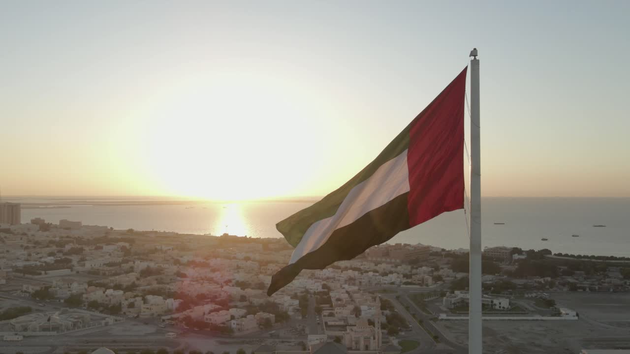 Aerial View: Flag of the United Arab Emirates waving in the wind, Sky ...