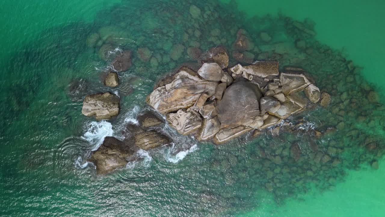 Premium stock video - Coral reef rock formations in the ocean peaking ...