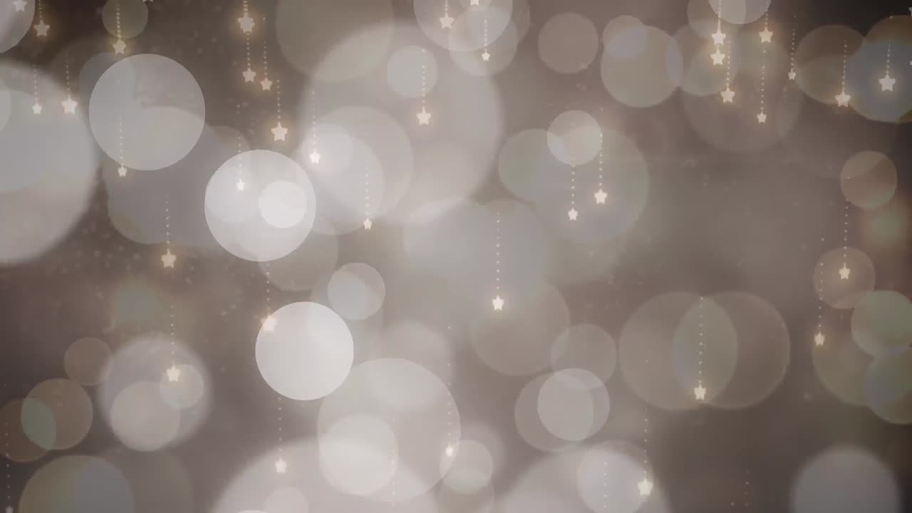 Animation of glowing christmas stars falling over blinking defocussed ...
