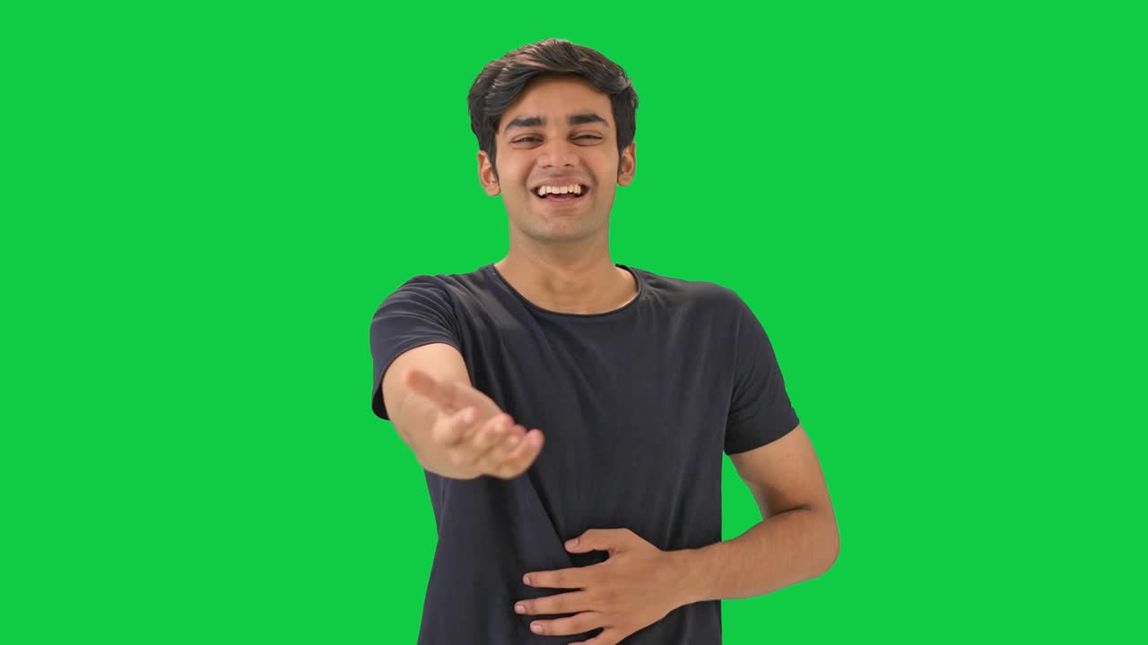 Premium stock video - Cute indian boy laughing on someone green screen