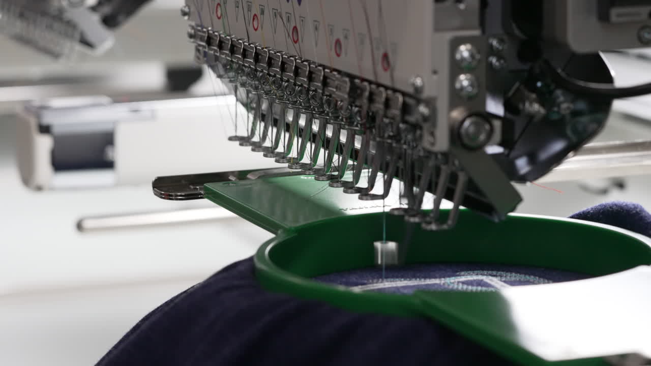 Premium stock video - Automated embroidery machine stitching design on ...
