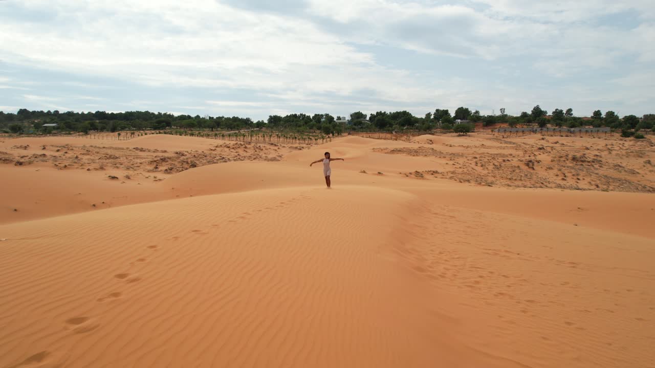 Slow Low Aerial Of Footsteps In The Sand As Woman Walks Top Of Dunes In ...