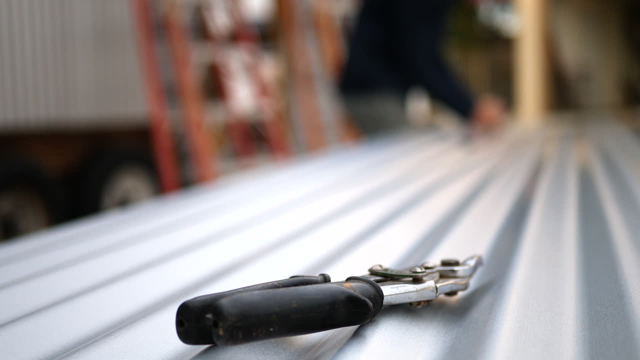 A pair of sheet metal tin snips on building materials at a construction ...