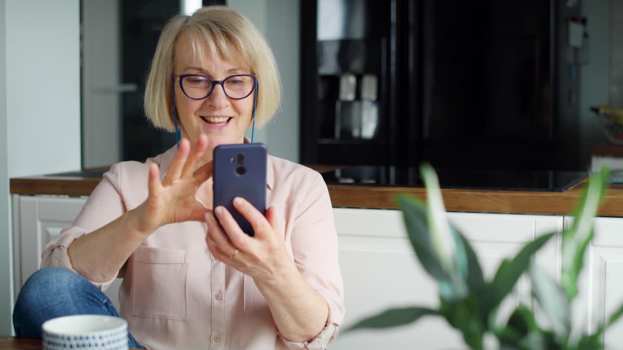 Premium stock video - Front view of smiling senior woman scrolling on ...