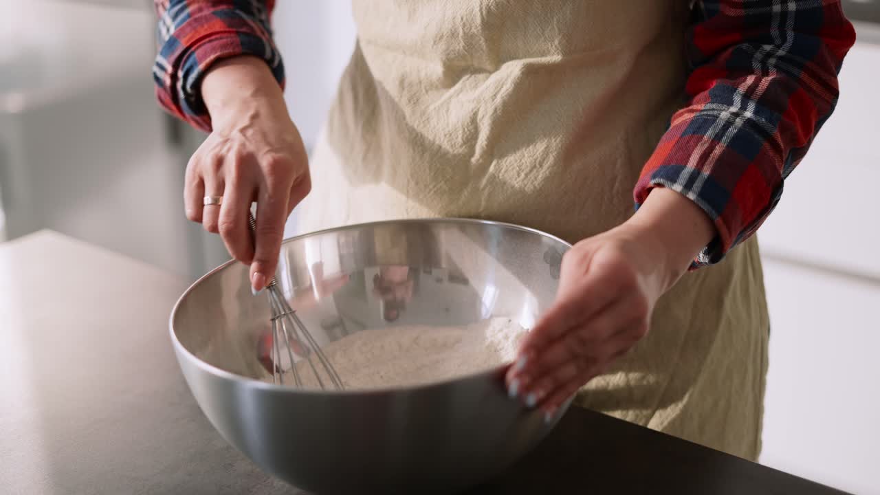 Free stock video - Young housewife mixing cake ingredients in bowl