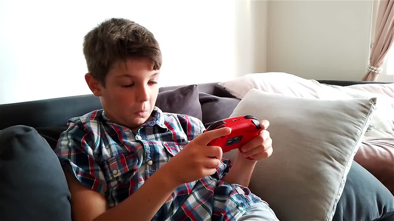 Boy is gaming video game on nintendo switch gaming console Premium ...