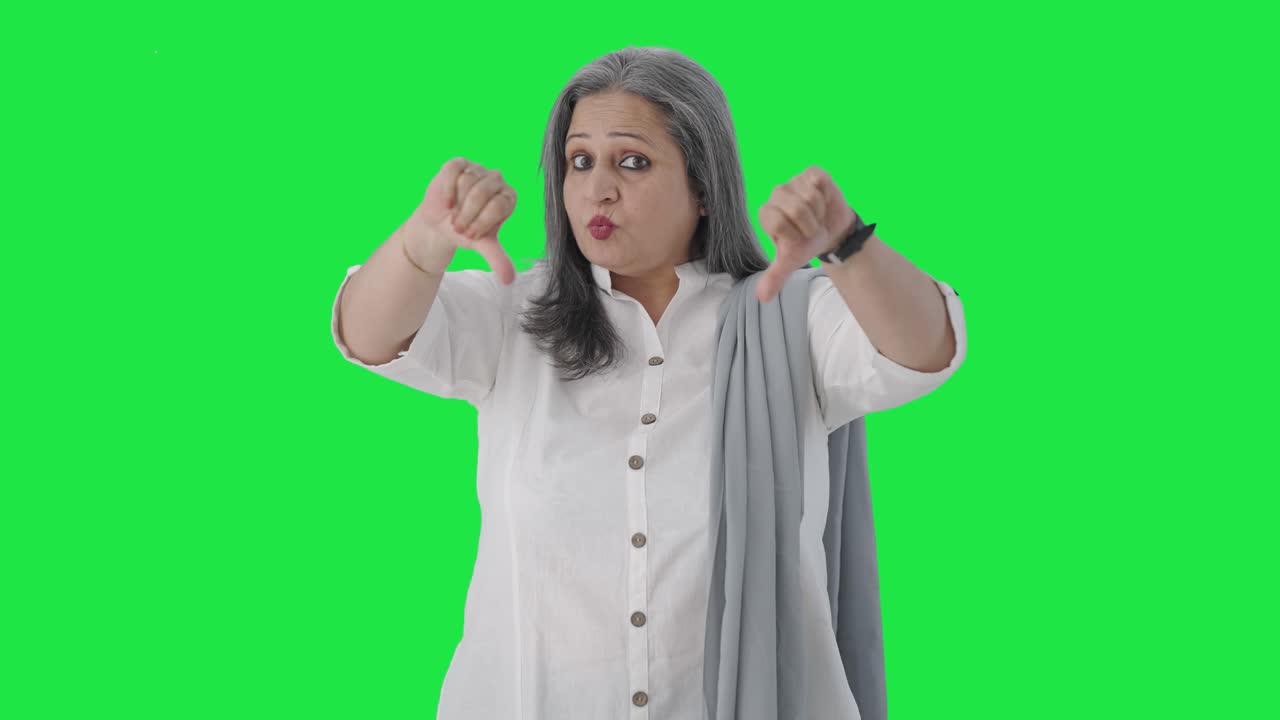 Disappointed indian senior businesswoman showing thumbs down green ...