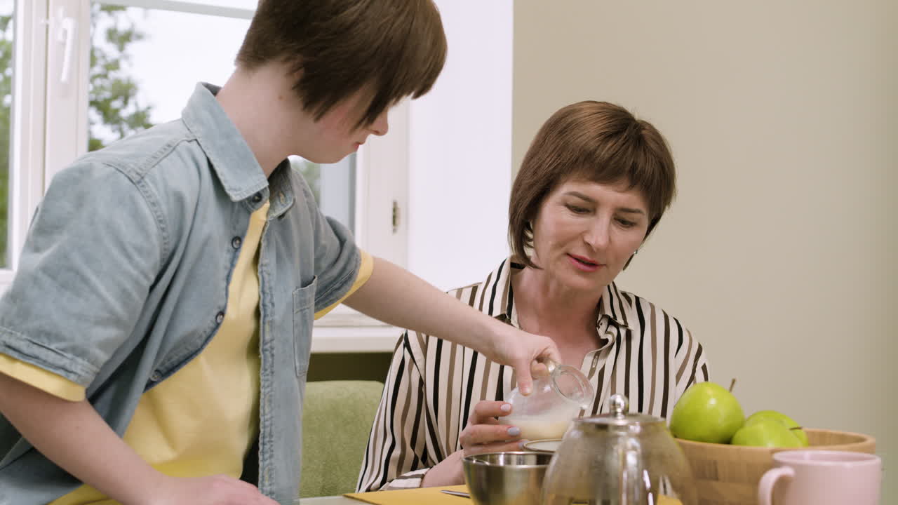 Mother Having Conversation With Her Daughter While Is Serving Milk Free Stock Video Footage ...