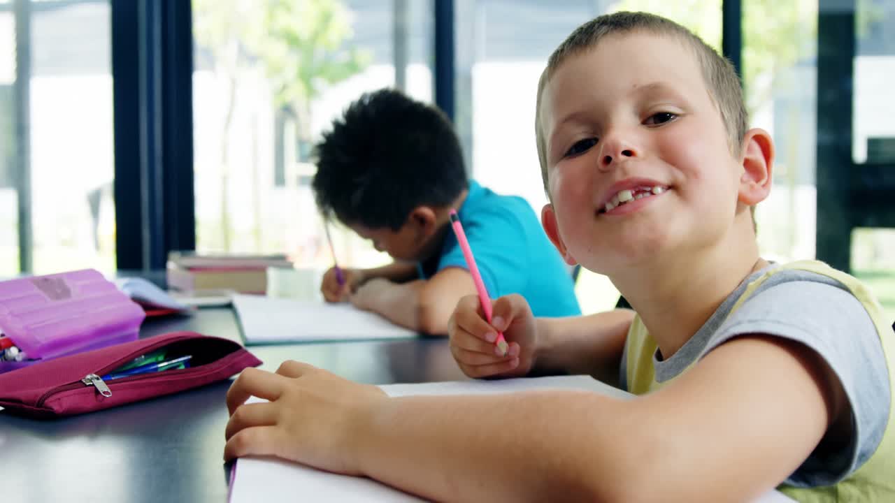 Premium stock video - School kids doing homework in classroom