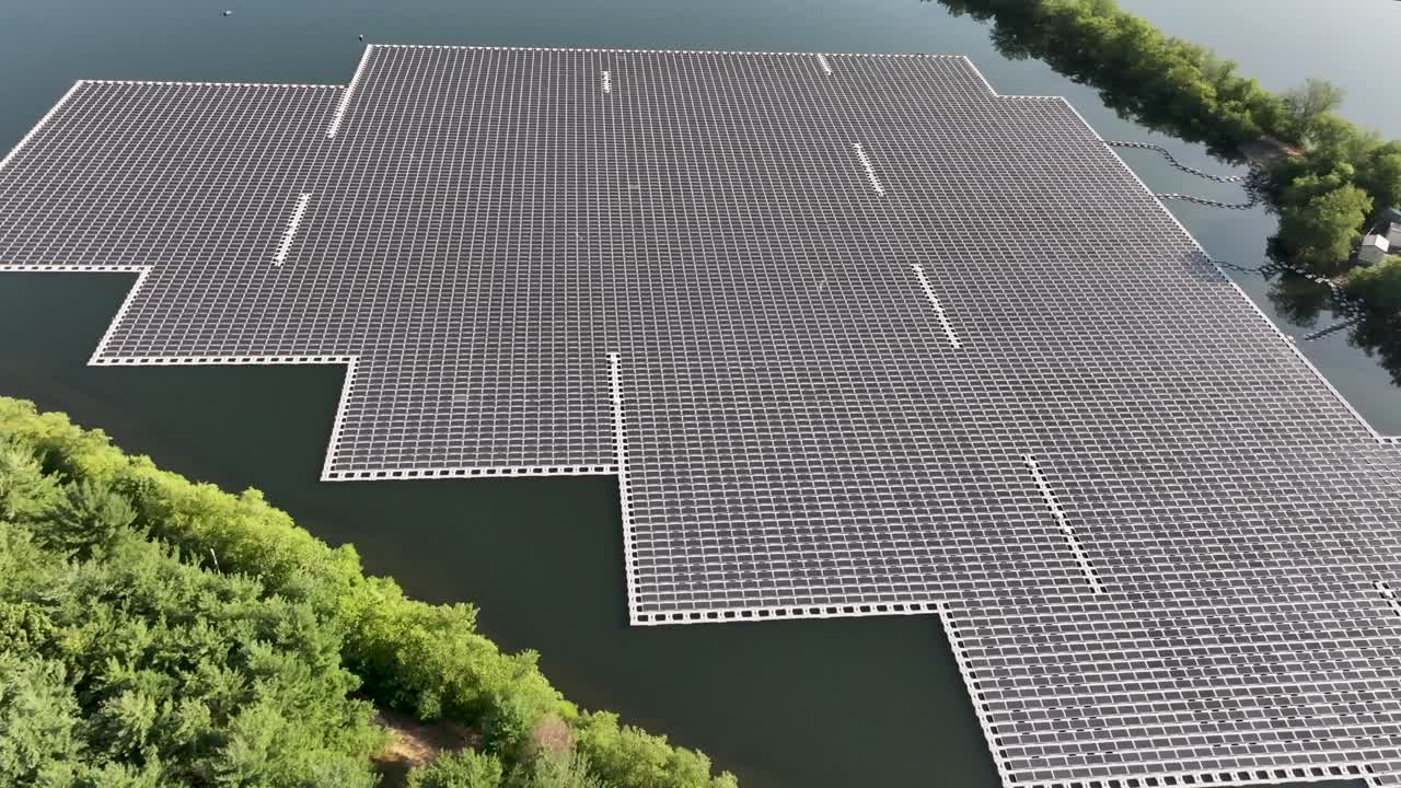Approaching aerial flight over a large floating solar panel array on a ...