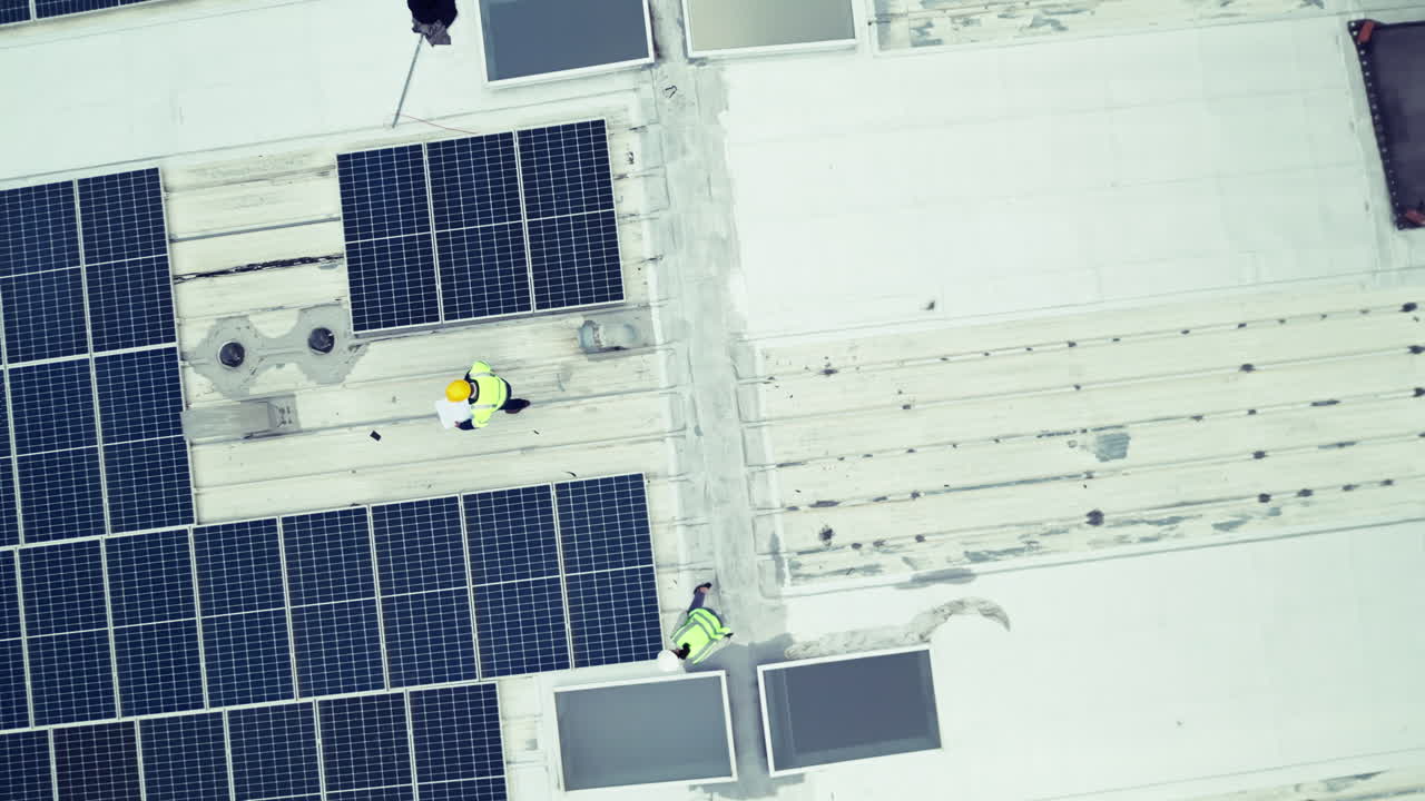 Premium stock video - Overhead, solar power and a construction worker