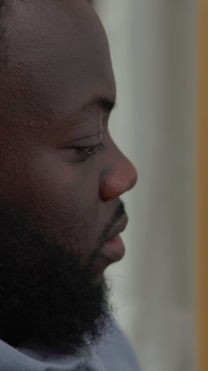 Vertical Video Of Black Male Looking Into Computer In Home Office ...