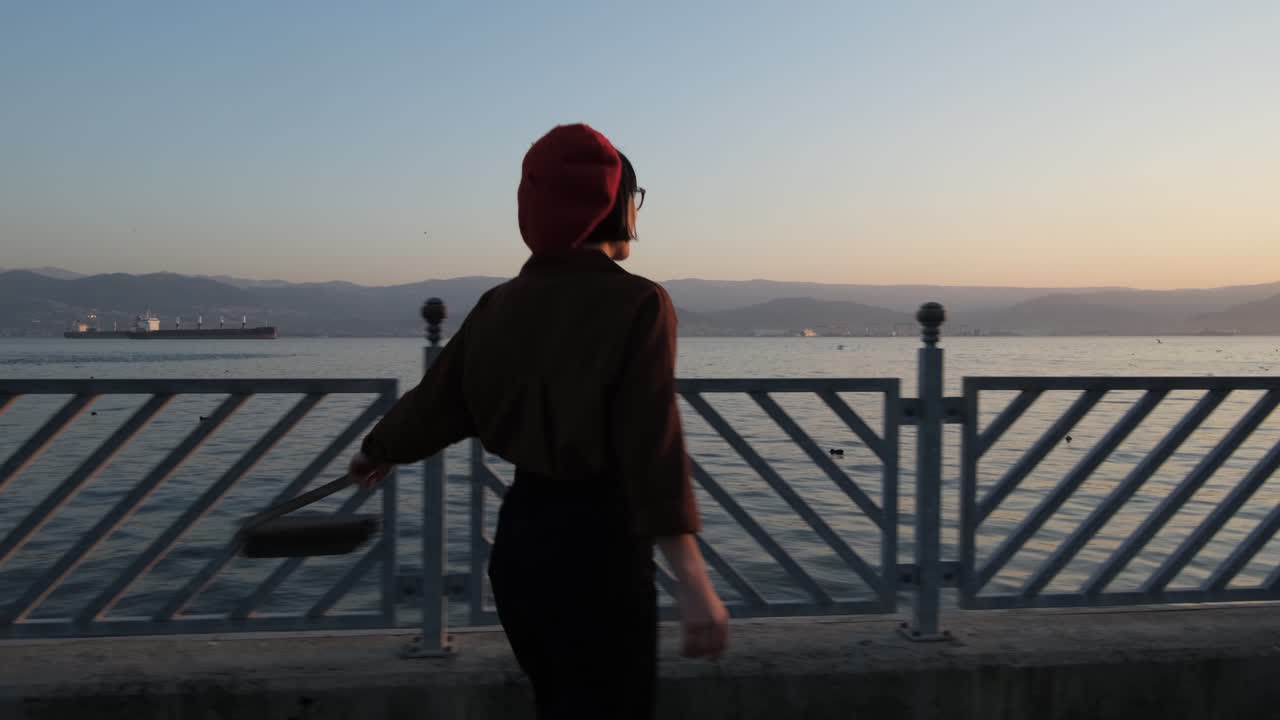 Premium stock video - Young woman hang out bay