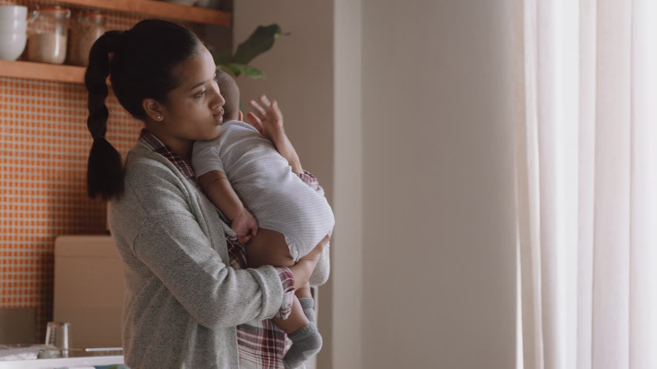 Premium stock video - Young mother holding baby calming restless ...