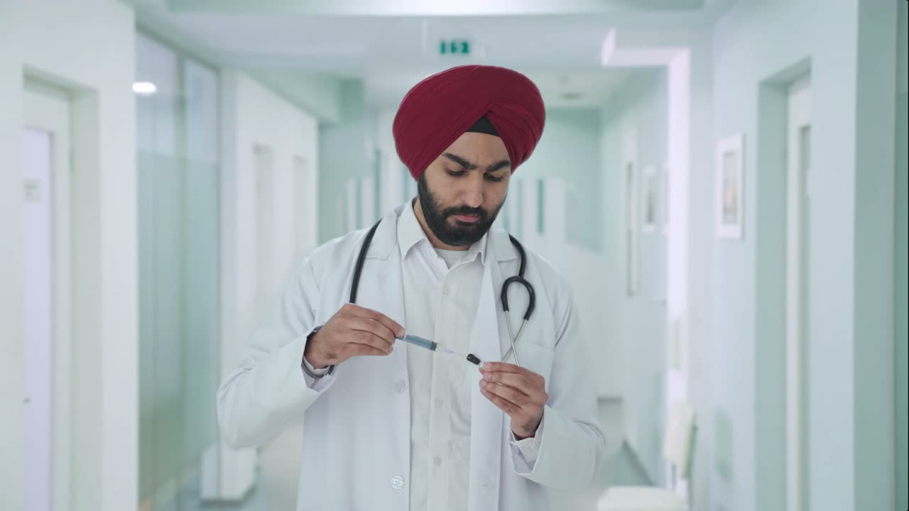 Sikh indian doctor filling up an injection Premium Stock Video Footage