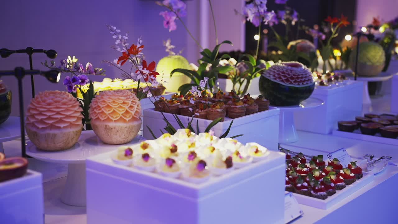 An array of beautiful pastries, artfully arranged on a pristine white ...
