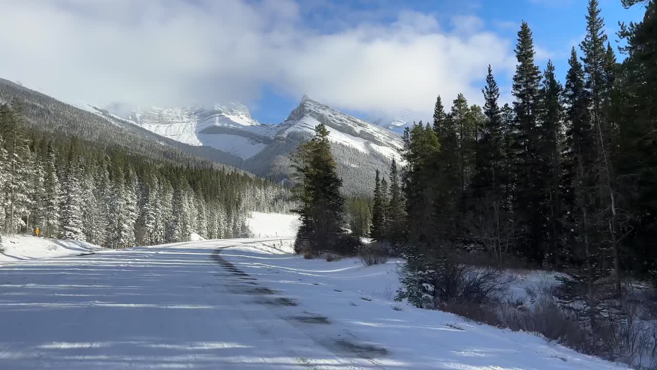 Driving on a backcountry road in the winter time in the mountains ...