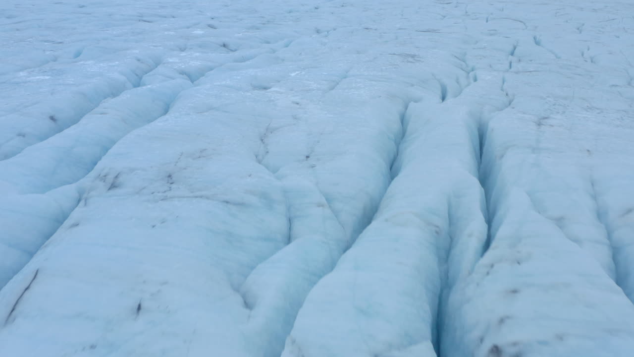 Aerial shot over thick ice sheet of a glacier | Premium Stock Video Footage