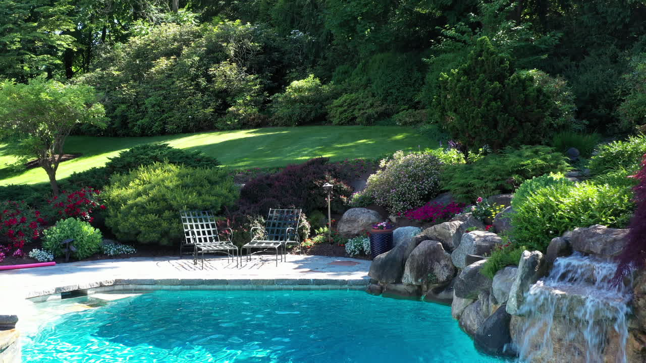 Premium stock video - A slow dolly shot over a beautiful summer pool ...