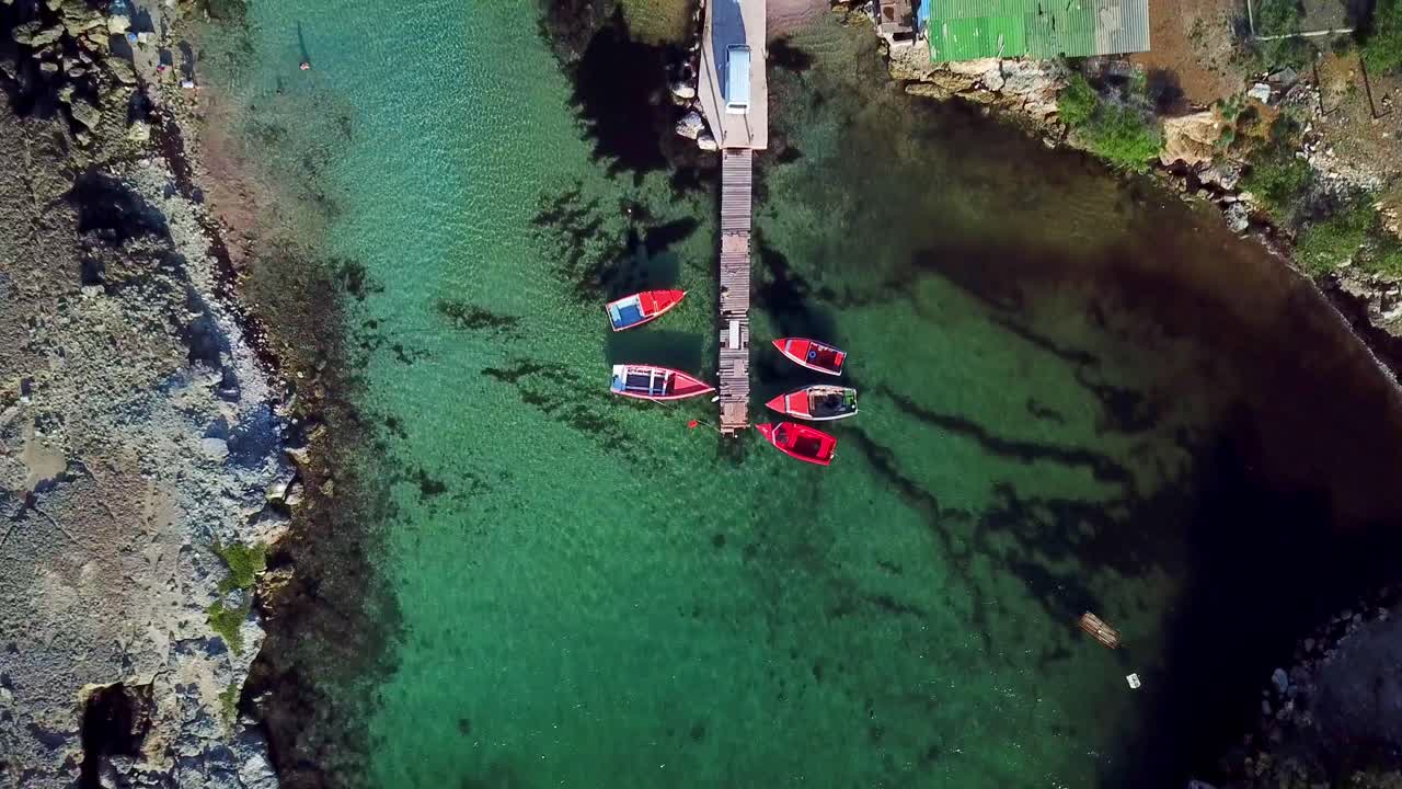 Dolly In Overhead View Of A Small Wooden Walkway With Fishing Boats On ...