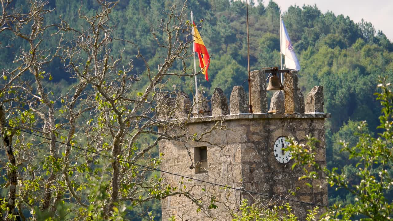 Close up sideview of clock tower in the town of Marce, Lugo, Spain ...