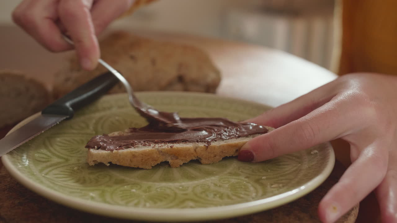 Girl Trying To Spread Chocloate Spread Free Stock Video Footage