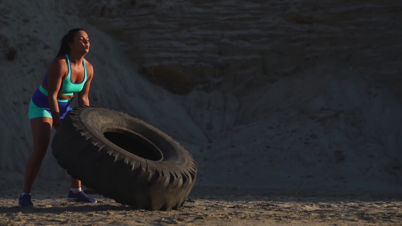 Girl On Sand Quarry Pushing Wheel In Training Crossfit Workout Free ...