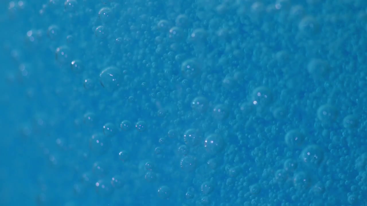 Premium stock video - Close up footage of blue fizzy bubbles