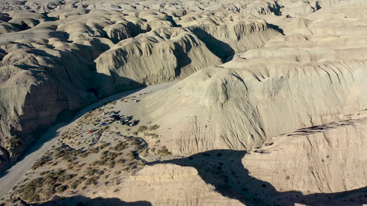 Aerial Flying Over Explorer's Campsite In Desert On Hot Dry Day ...
