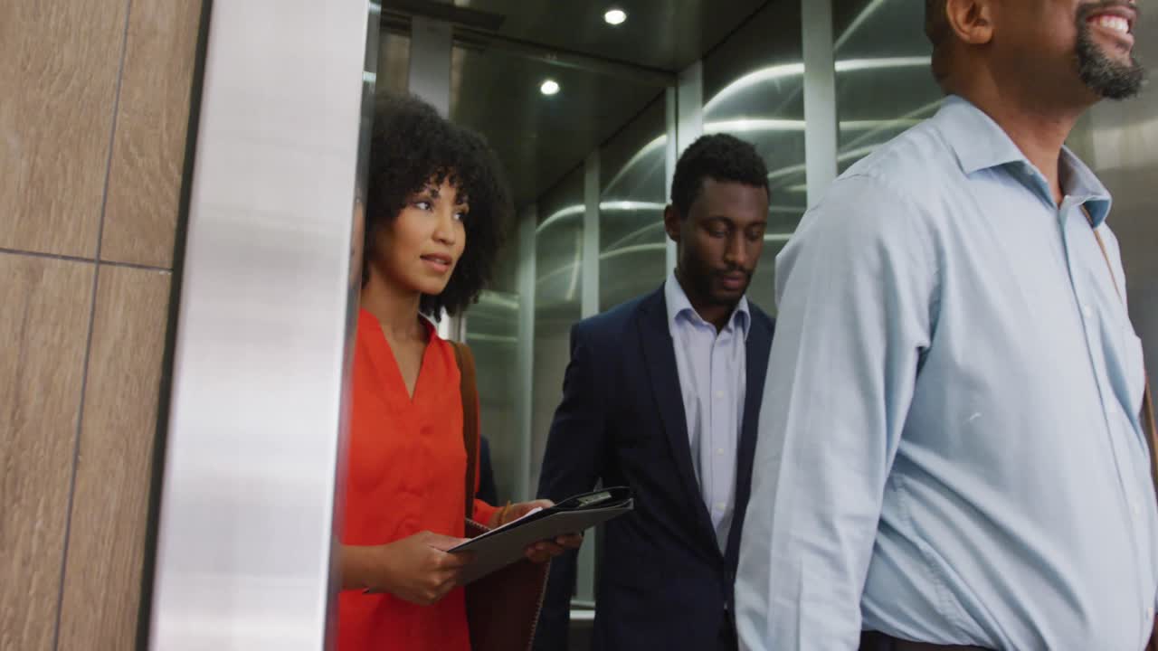 Premium stock video - Happy diverse business people taking elevator at ...